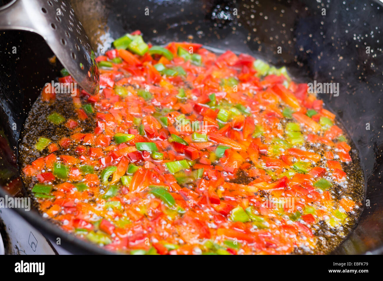 Frying ingredients to make a traditional spanish paella Stock Photo - Alamy