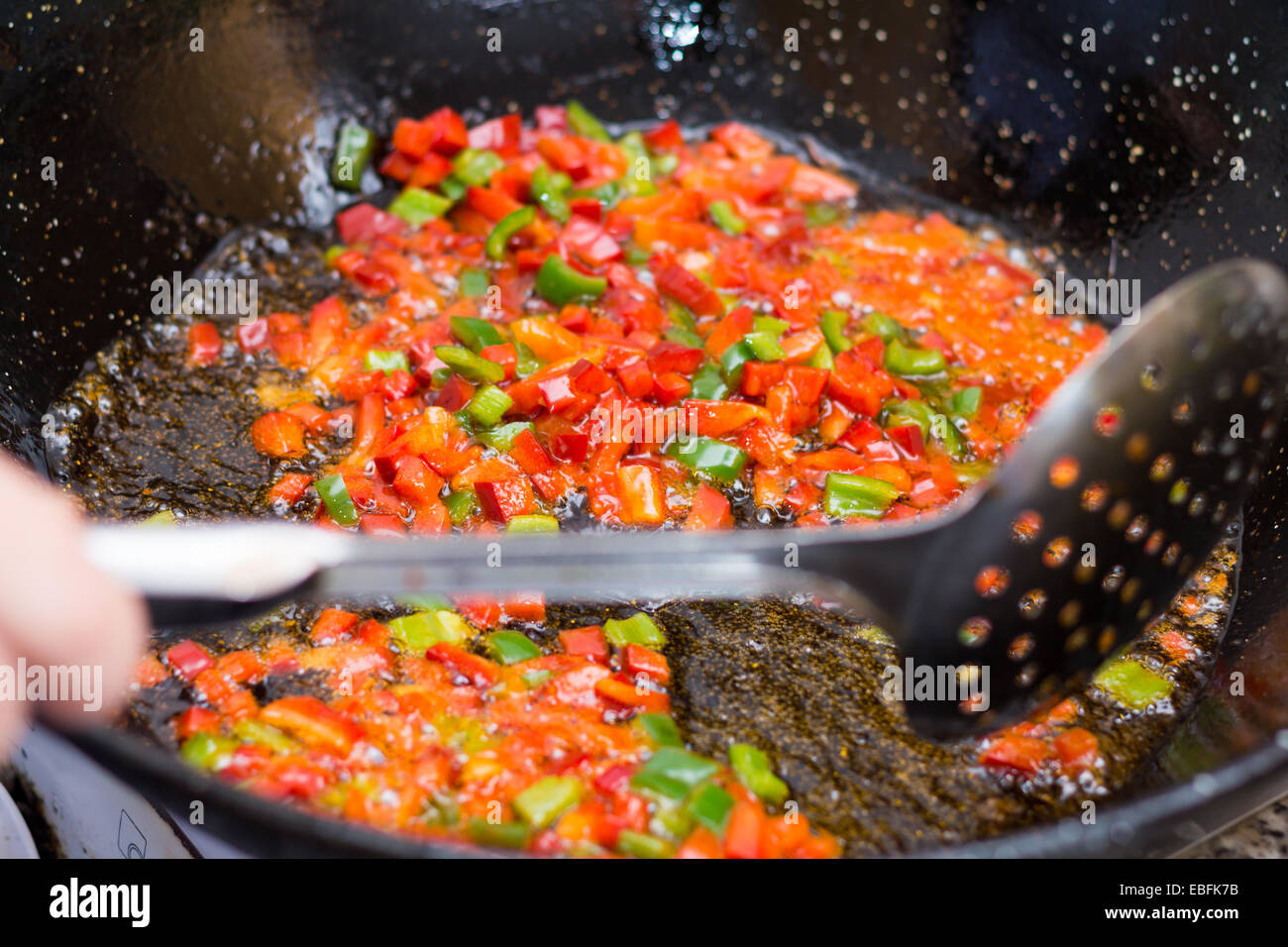 Frying ingredients to make a traditional spanish paella Stock Photo - Alamy