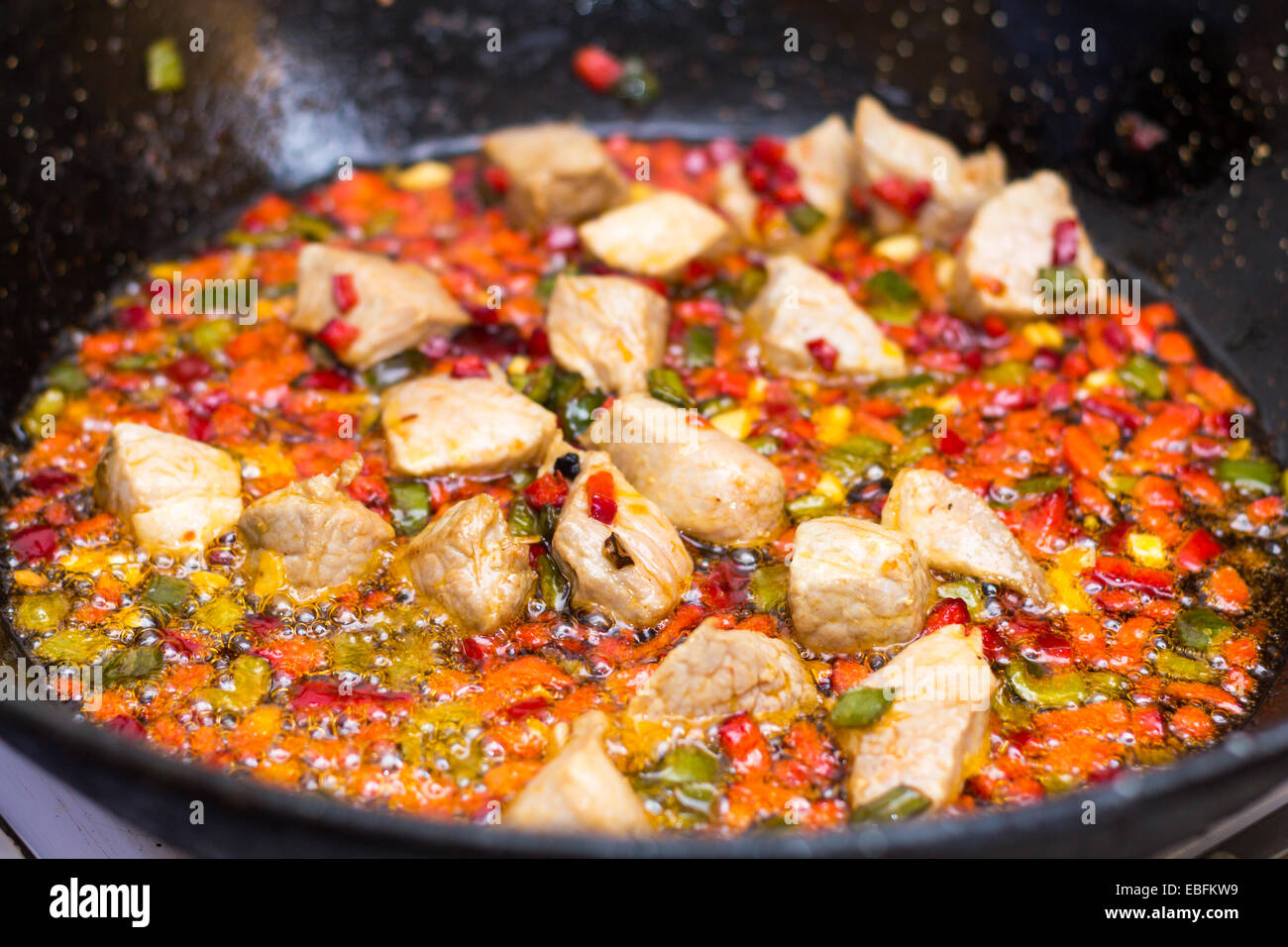 Frying ingredients to make a traditional spanish paella Stock Photo - Alamy