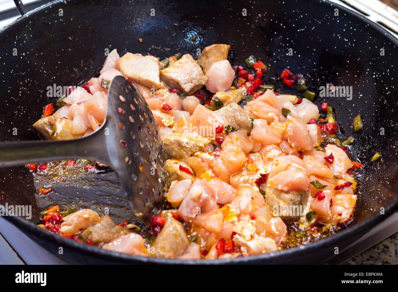 Frying ingredients to make a traditional spanish paella Stock Photo - Alamy