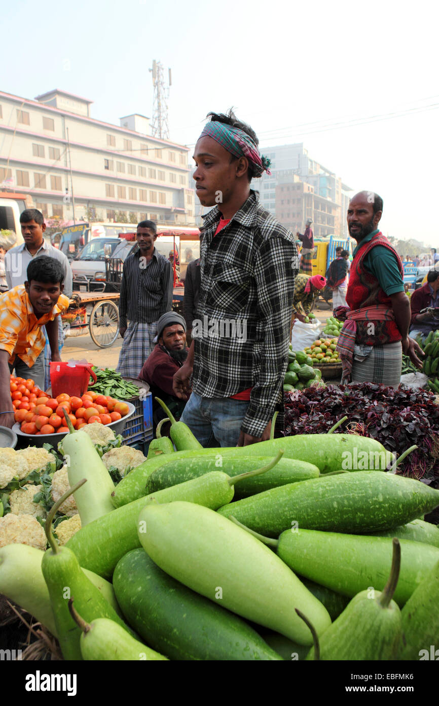 Men working at a fruit and vegetable market in Dhaka, Bangladesh. They sell fresh produce ...