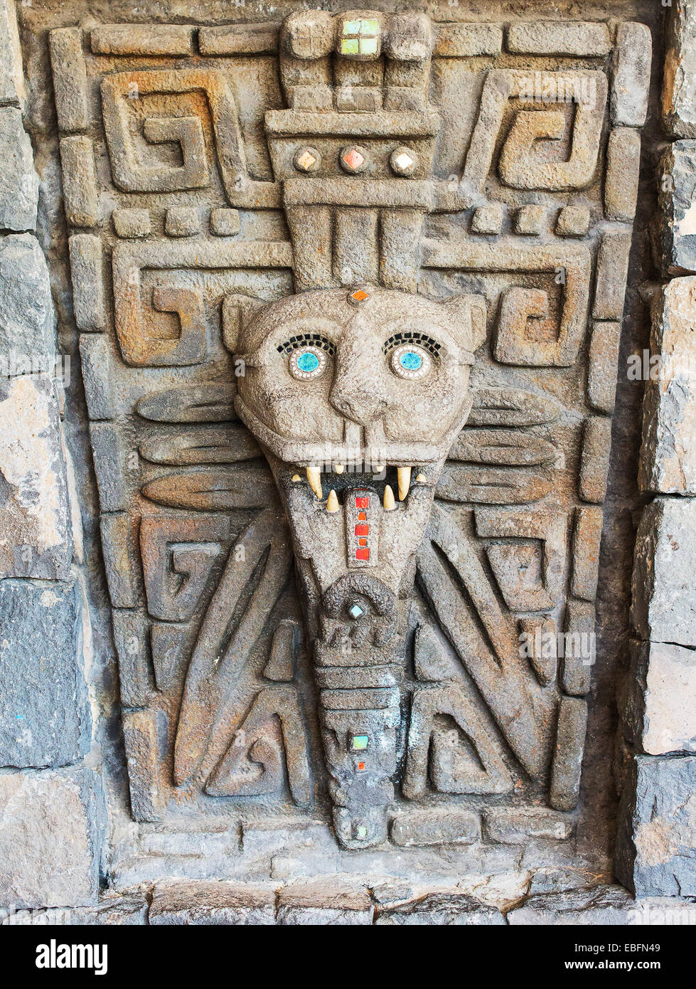 Ancient stone door with mask on it Stock Photo - Alamy