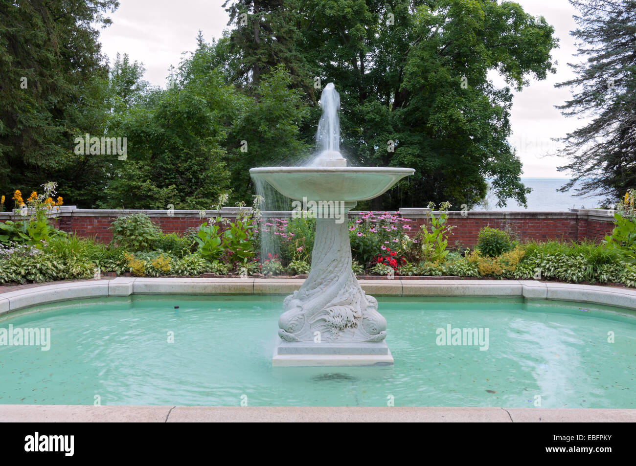 ornate fountain and pool inside botanical garden of a historic estate ...