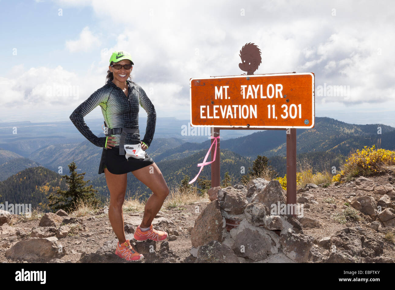 Runner reaches the summit during the Mt Taylor 50k Stock Photo - Alamy