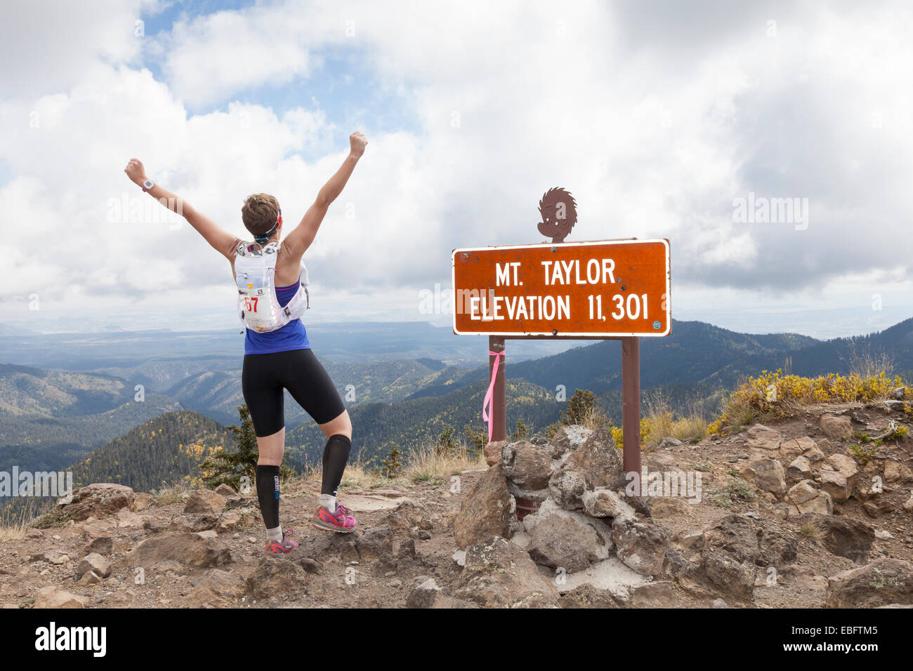 Runner reaches the summit during the Mt Taylor 50k - Mt Taylor, San ...