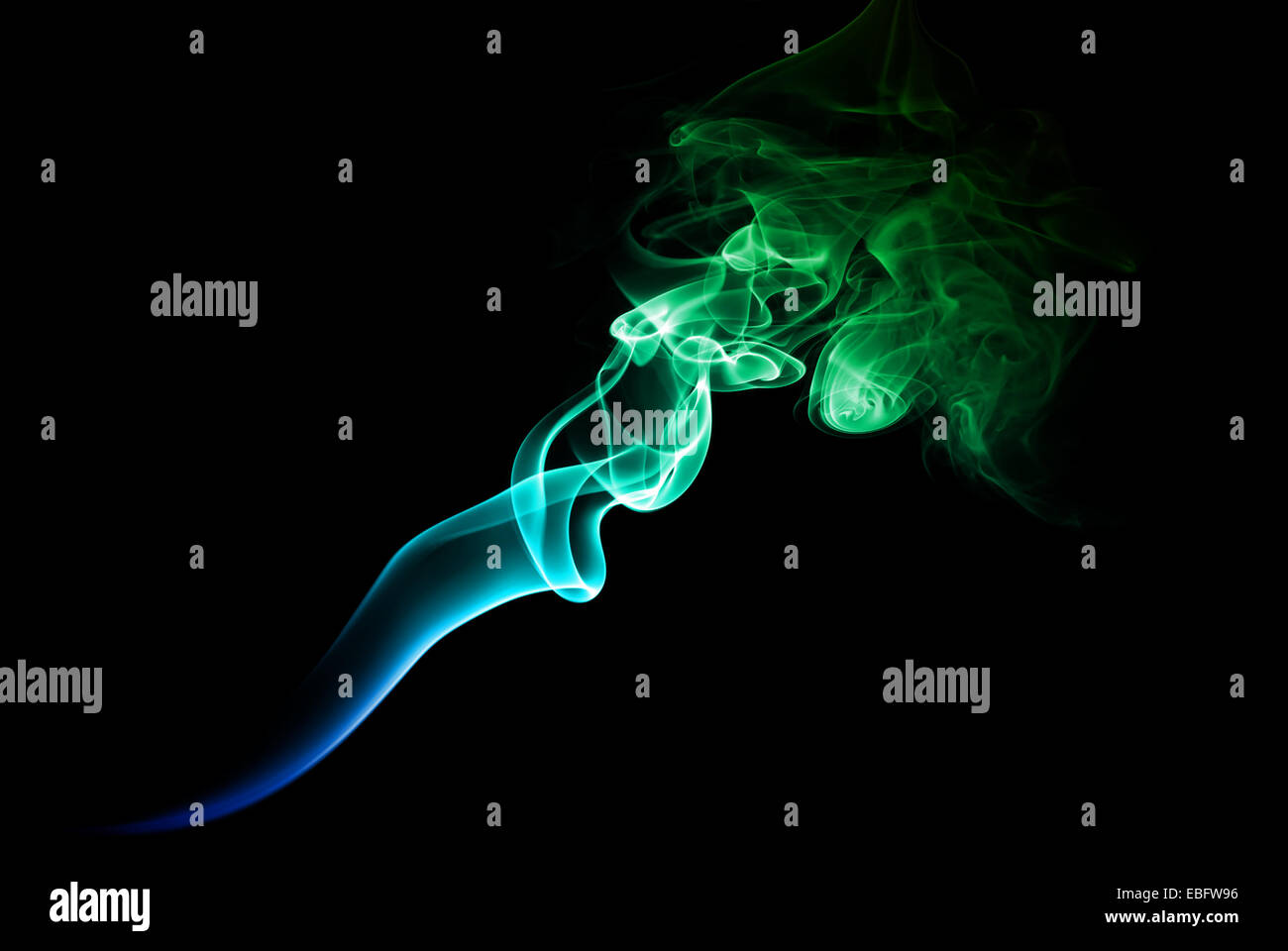 Green and blue smoke on a dark background Stock Photo - Alamy
