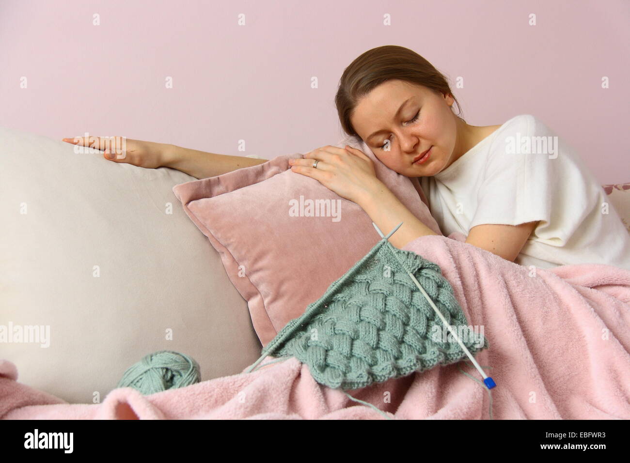 tired young woman sleeping on sofa Stock Photo - Alamy