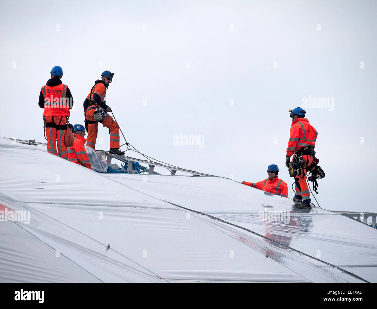 Workmen installing the ETFE pneumatic panels which form the new roof of ...