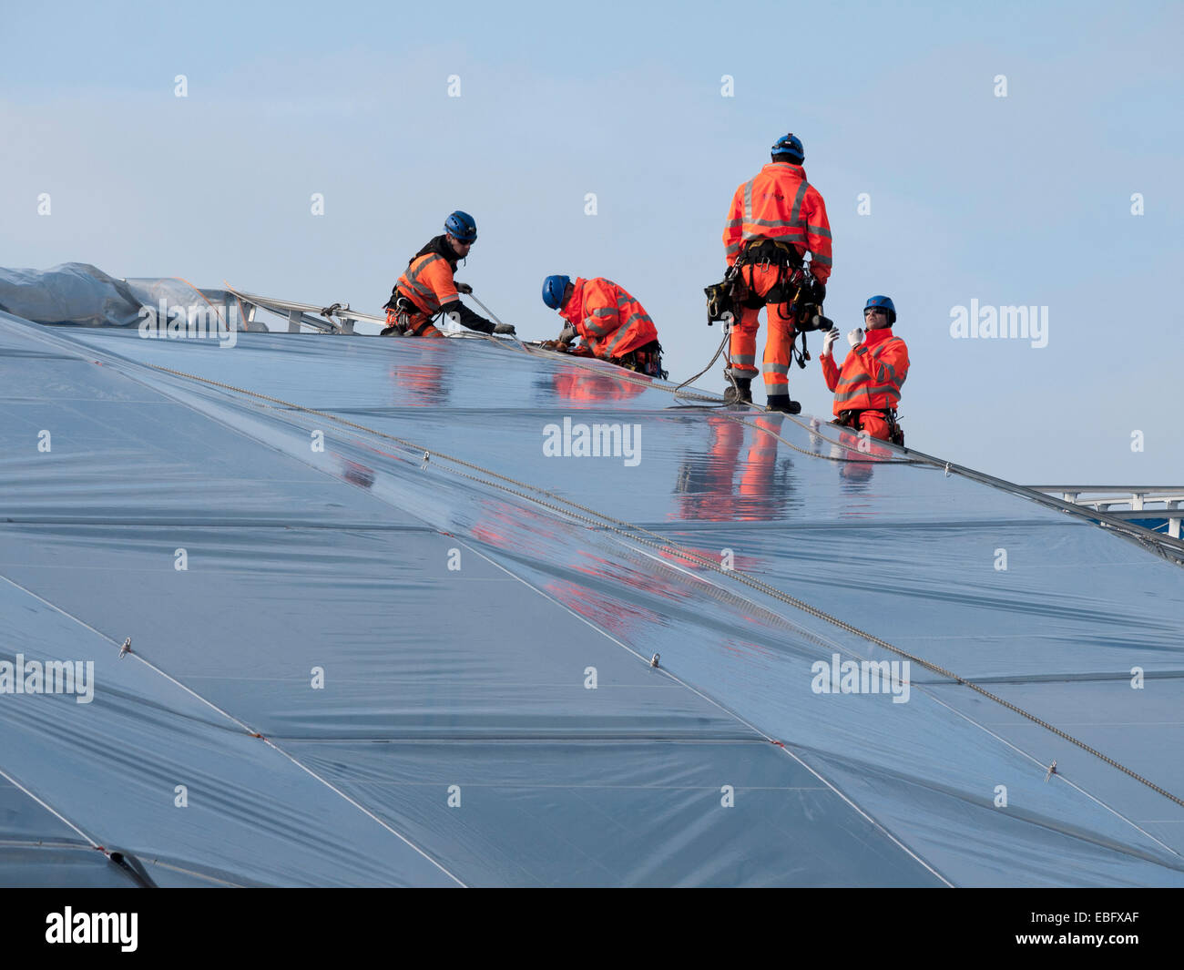 Workmen installing the ETFE pneumatic panels which form the new roof of ...