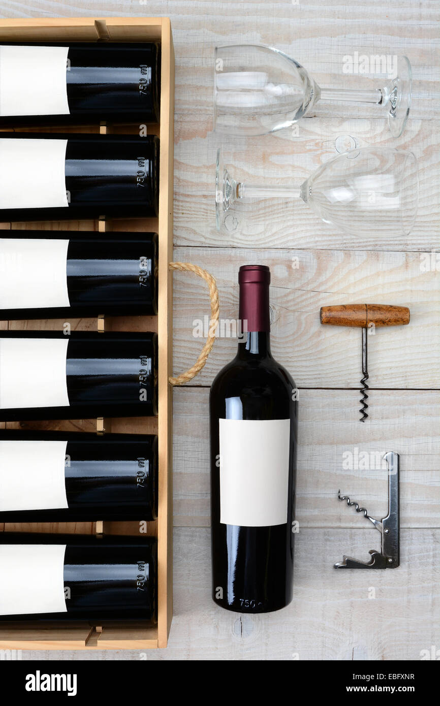 High angle shot of a case of red wine bottles next to a single bottle ...