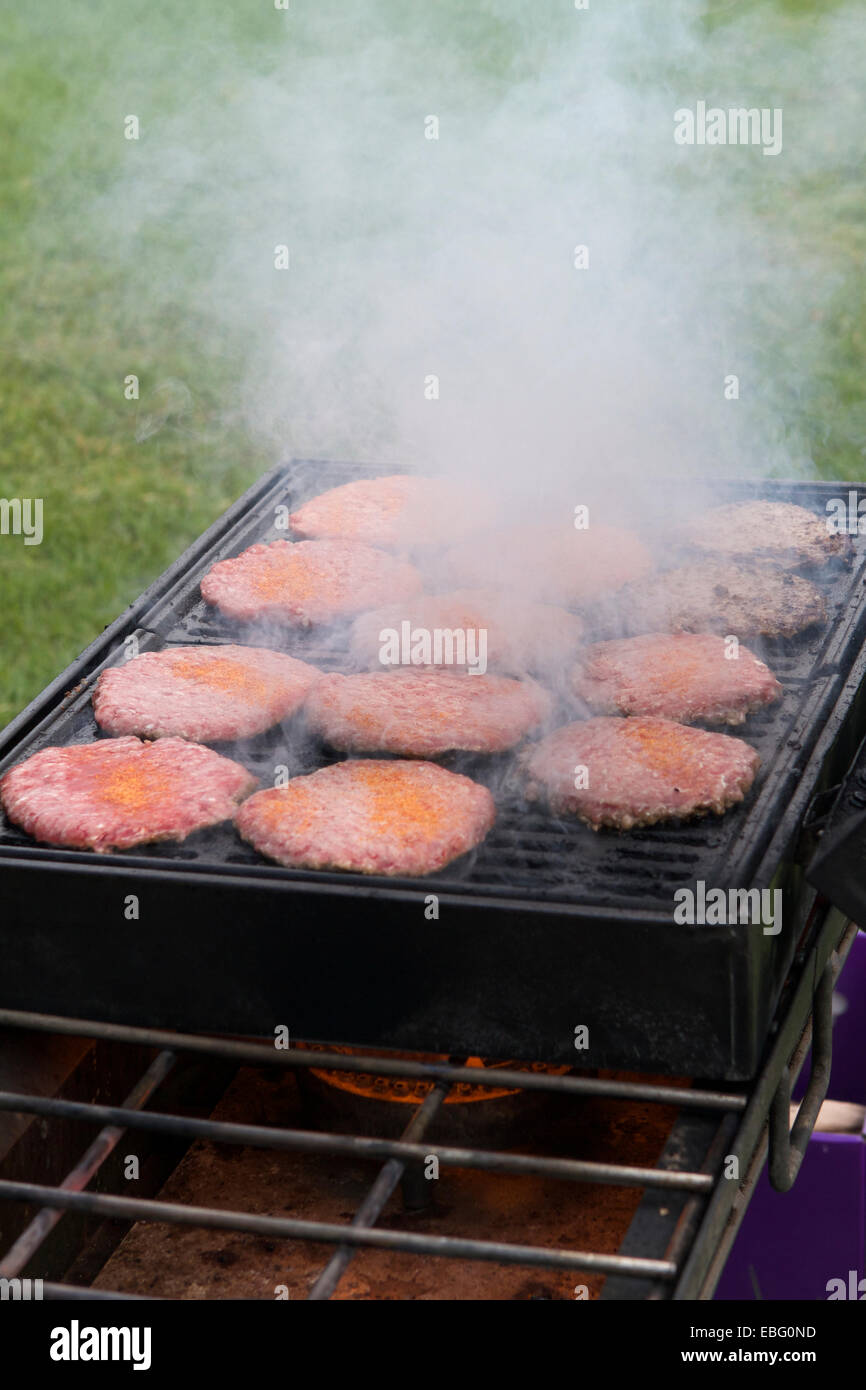 burgers cooking on a outside Barbecue Stock Photo - Alamy