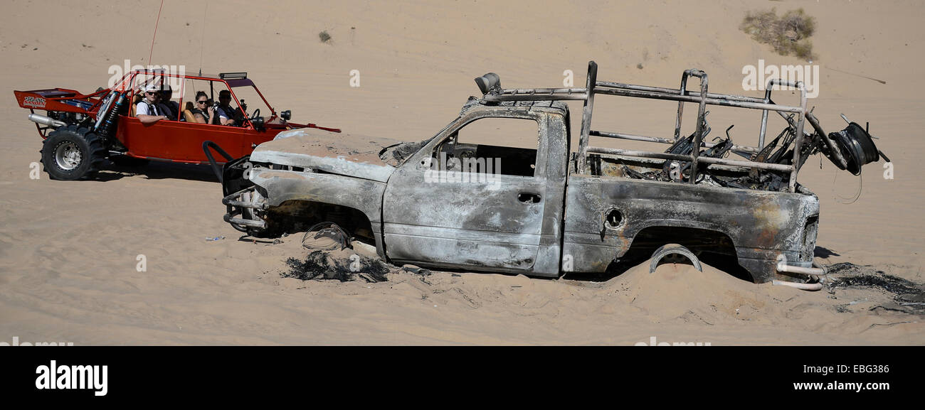 A burnout pickup truck lays in the sand after it crash along sand ...