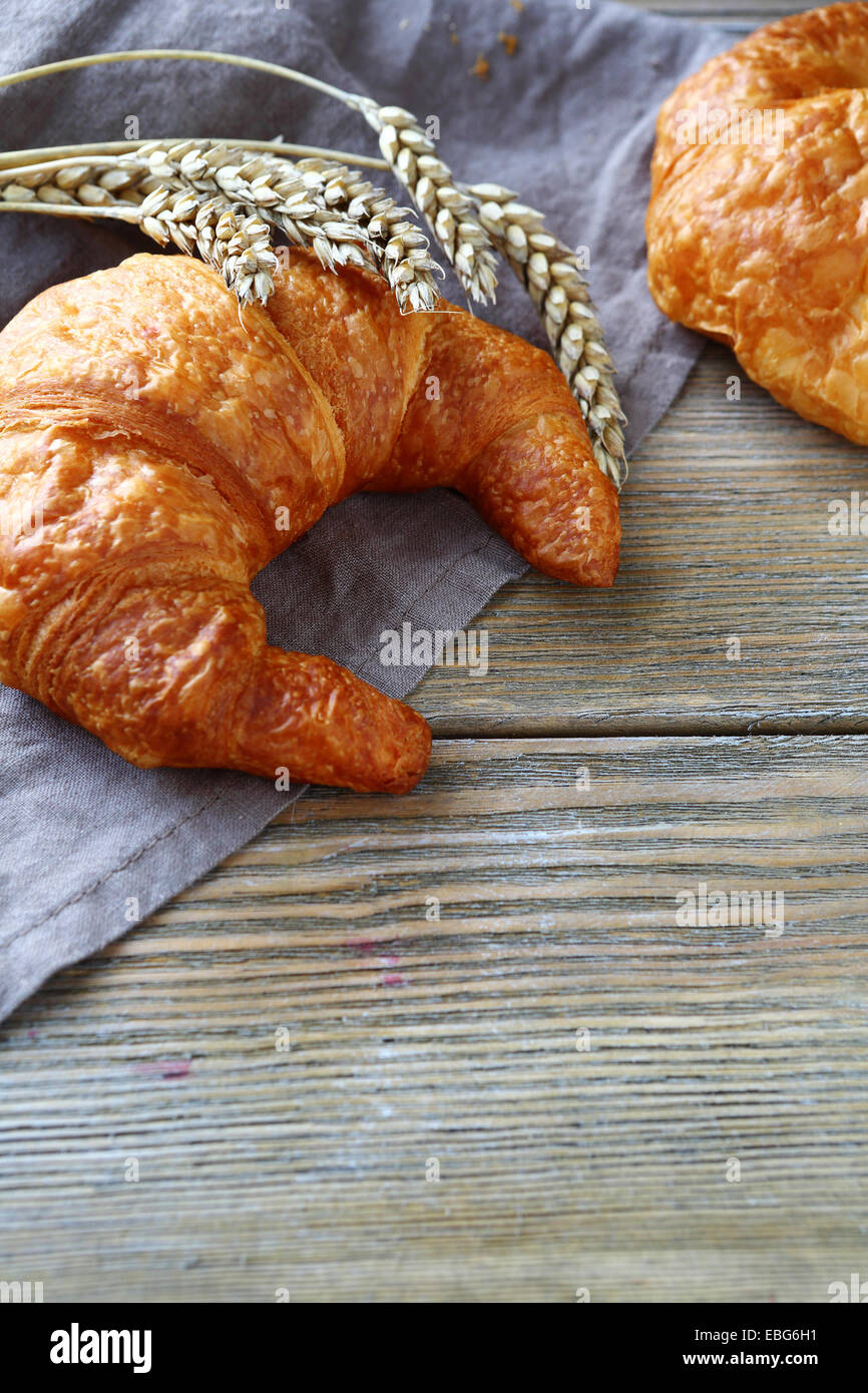 Croissant with wheat spikelets, food close-up Stock Photo - Alamy