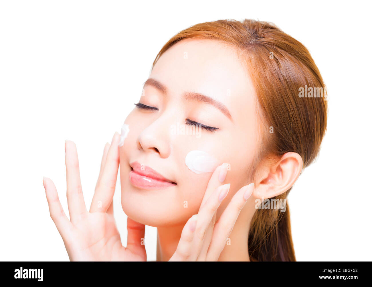beautiful young woman applying cosmetic cream on her face Stock Photo - Alamy