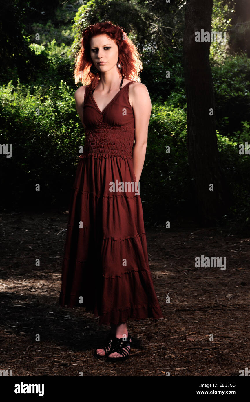Red dresses woman in a forest Stock Photo - Alamy