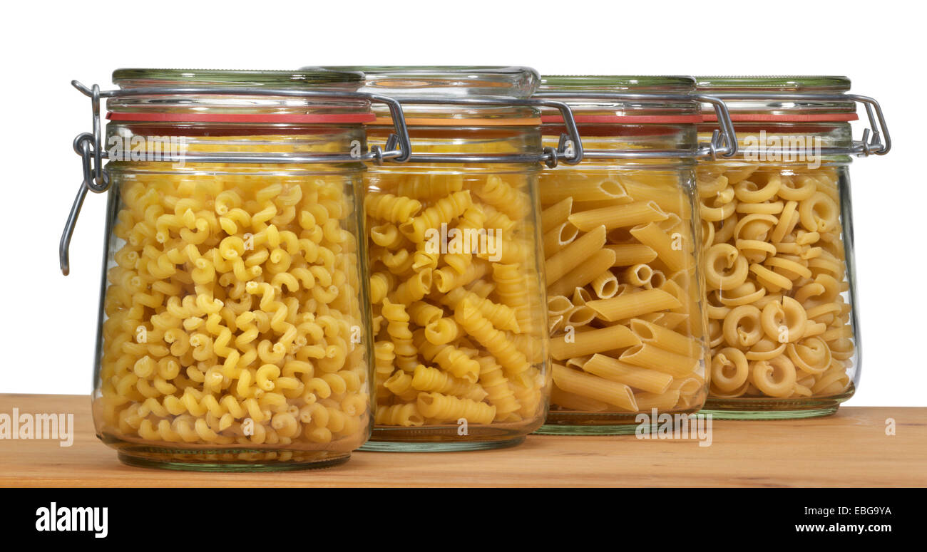 wooden board and some preserving bottles made of glass filled with ...