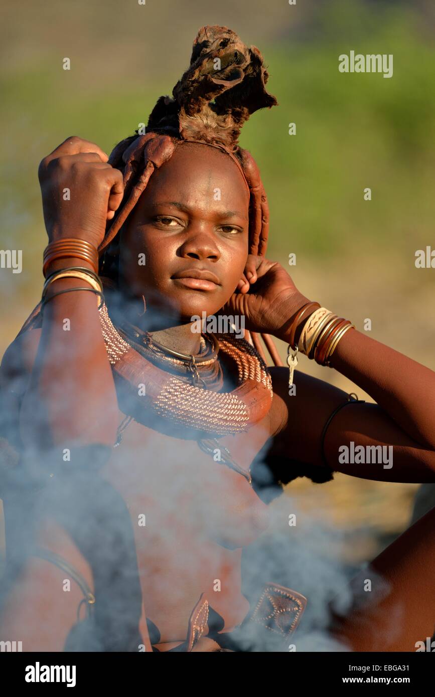 Young Himba woman at a campfire, Ombombo, Kaokoland, Kunene, Namibia ...