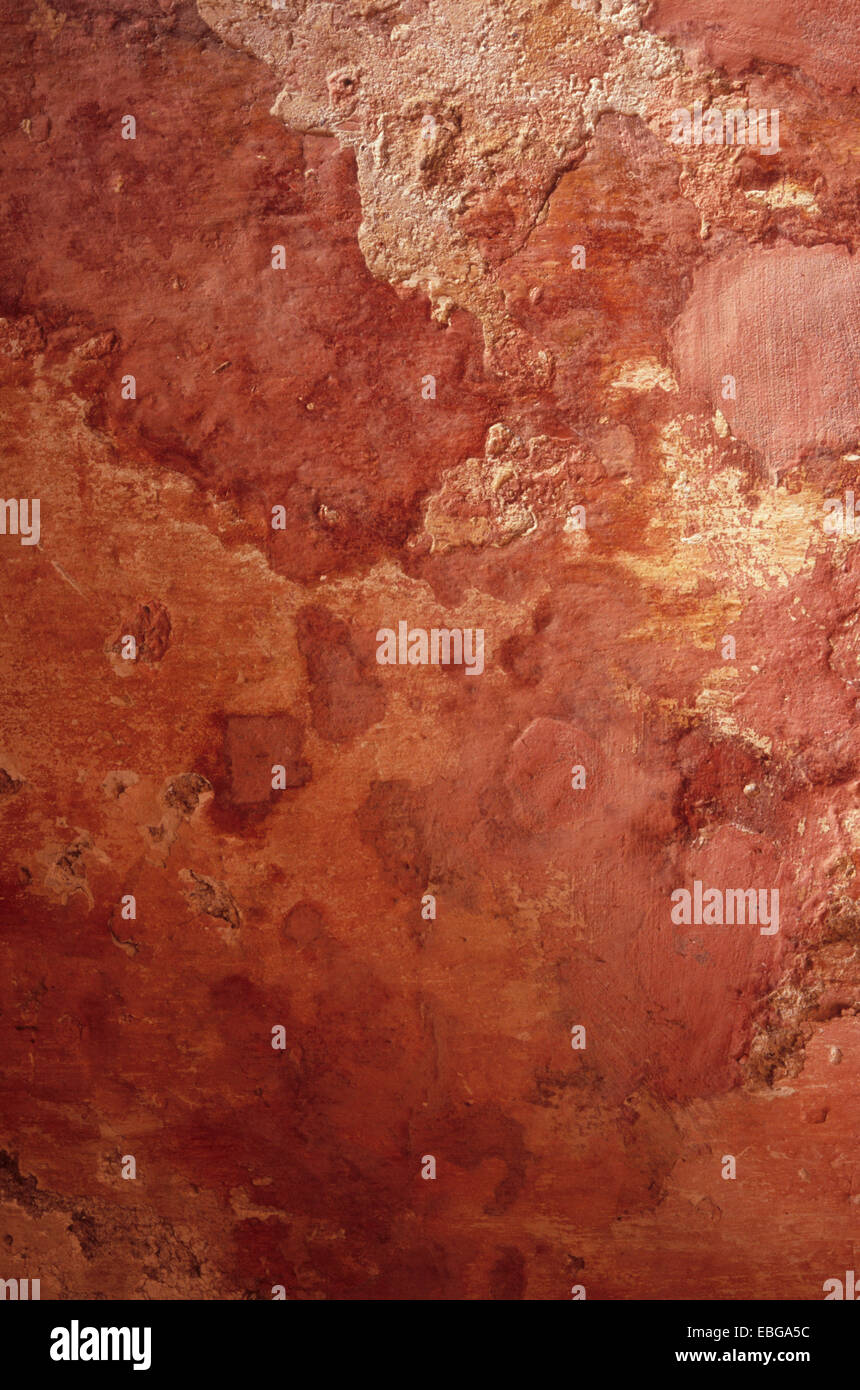 Detail of ochre coloured wall with repeated repairs to plaster Stock ...