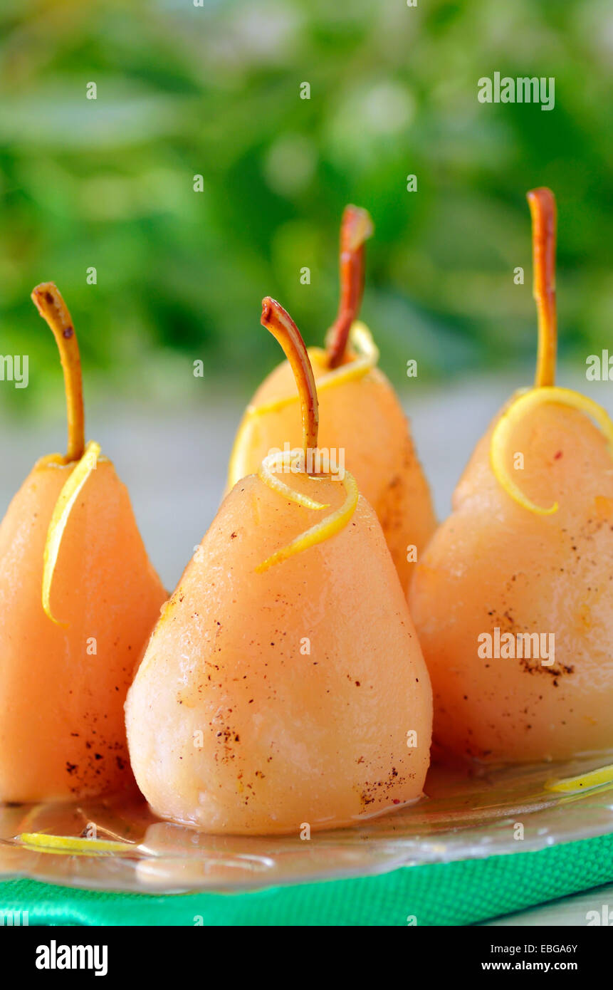four pears poached in syrup Stock Photo - Alamy