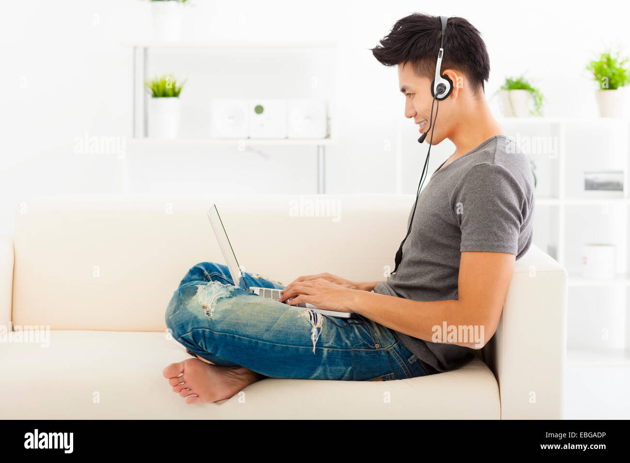 Young man sitting laptop computer hi-res stock photography and images ...