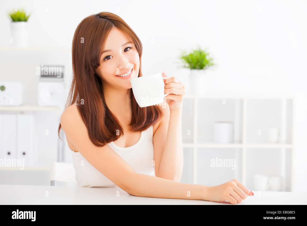 happy asian young drinking coffee Stock Photo - Alamy