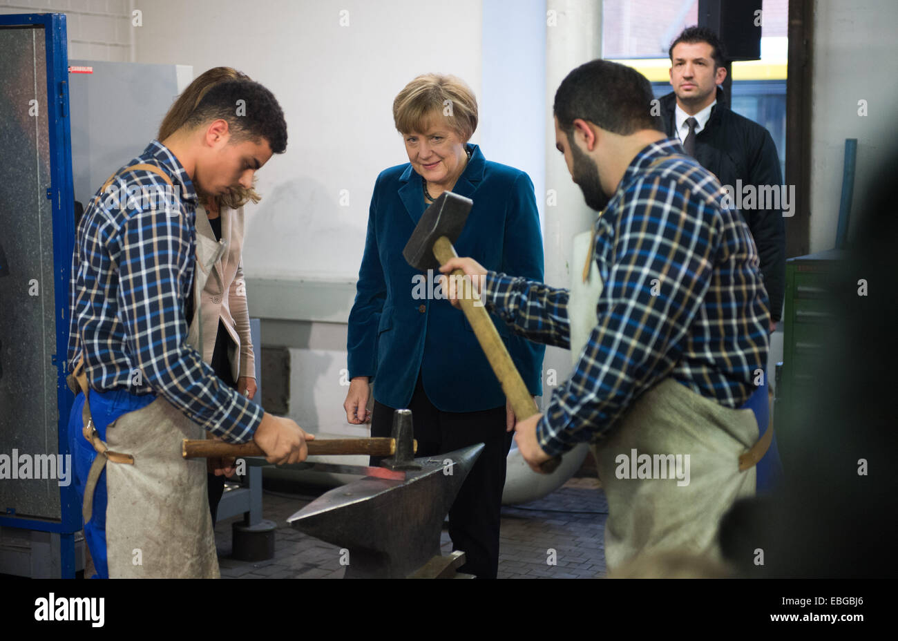 Berlin, Germany. 01st Dec, 2014. Chancellor Angela Merkel watches young ...