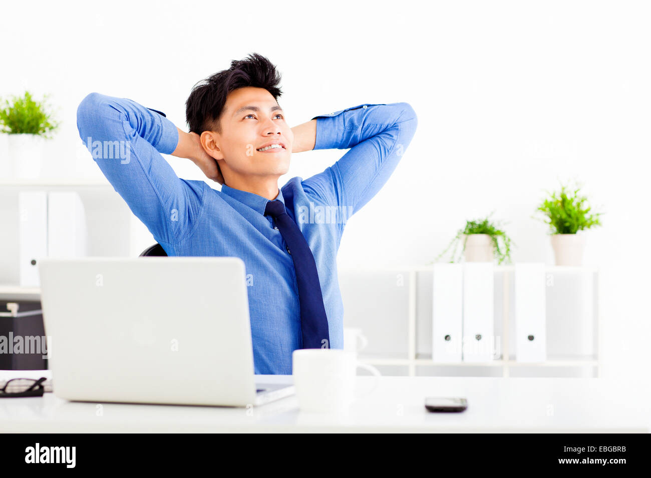 relaxed Young businessman working in the office Stock Photo - Alamy
