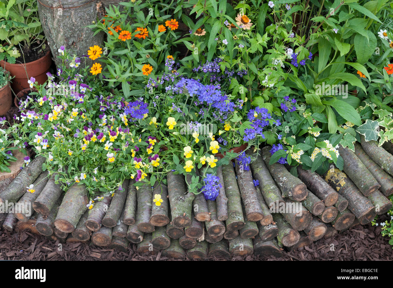 wildlife part of garden with attracting plants and stacked logs for ...