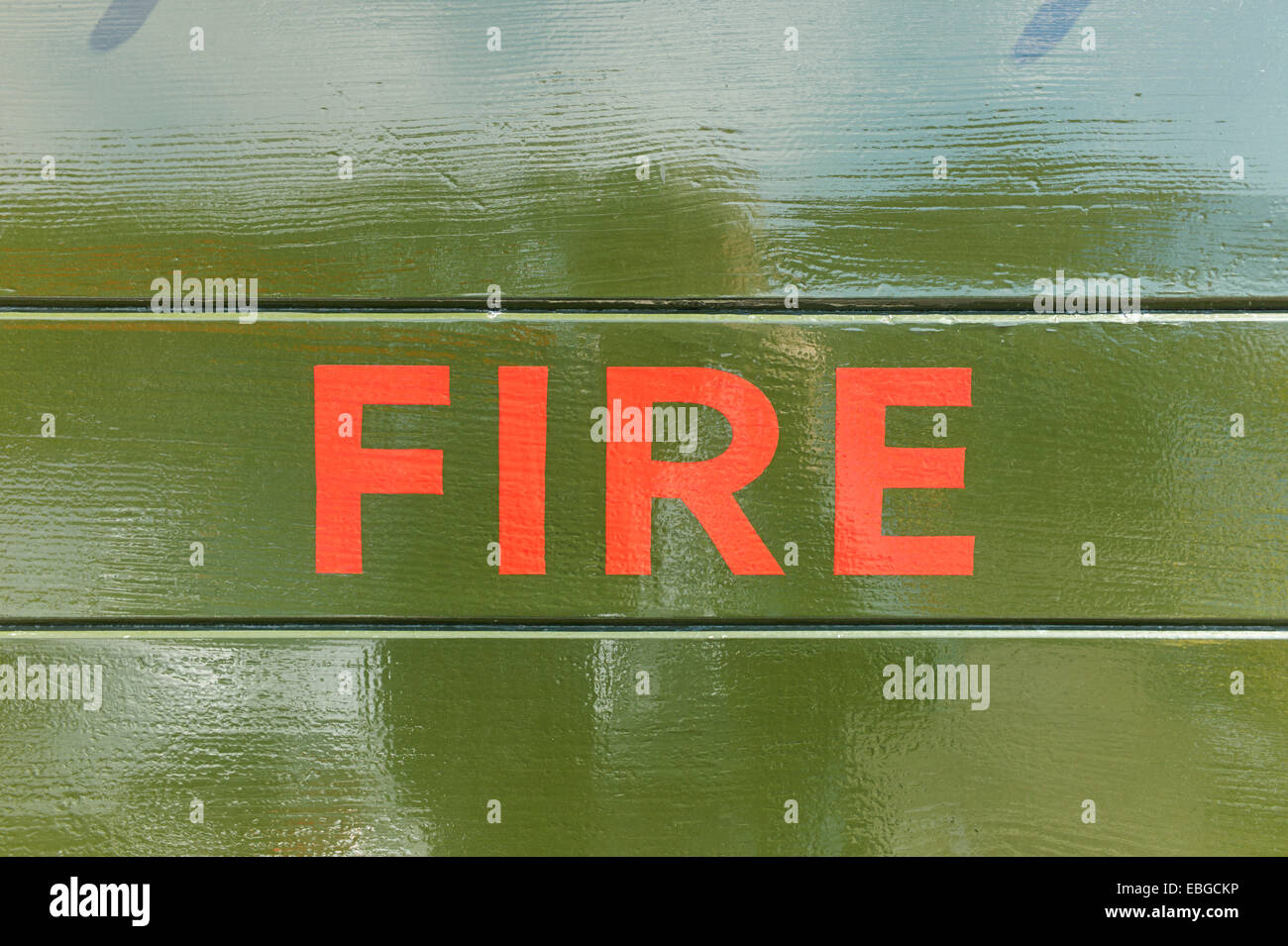 Fire painted in red on wooden background Stock Photo - Alamy