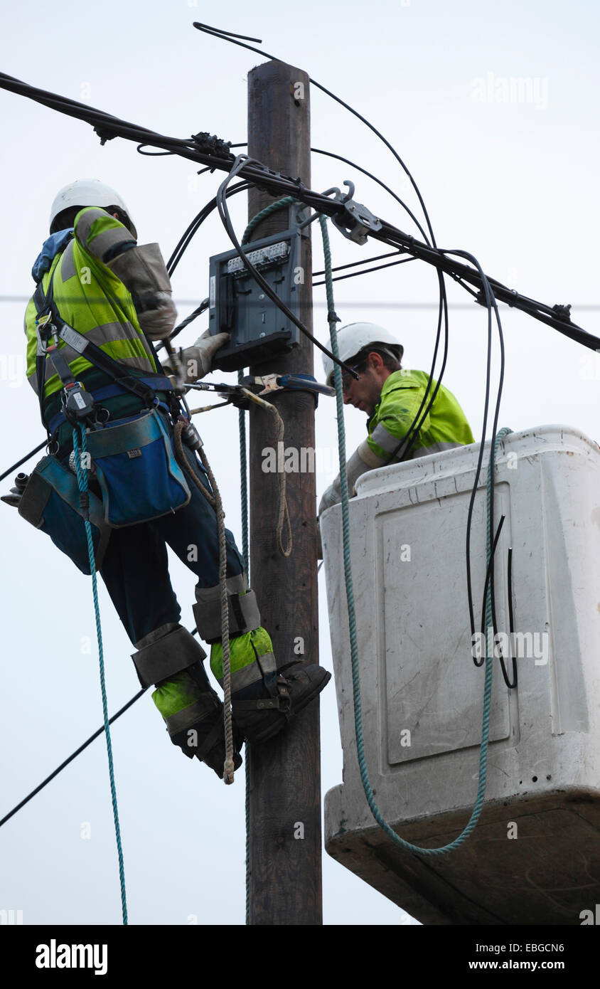 Two power supply workers replacing electric cables Stock Photo - Alamy