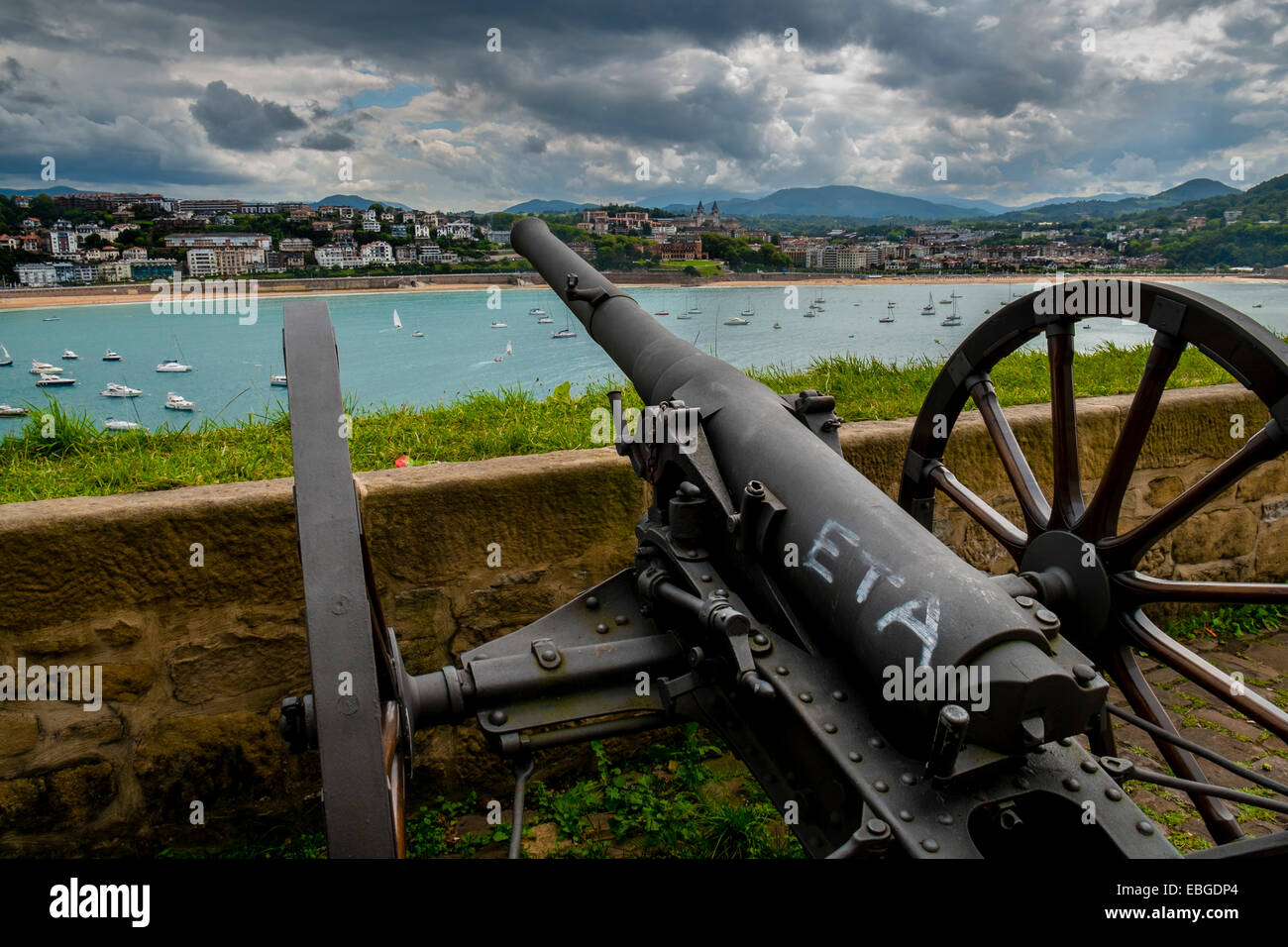 A fortification gun with ETA grafitti overlooks the town of San ...