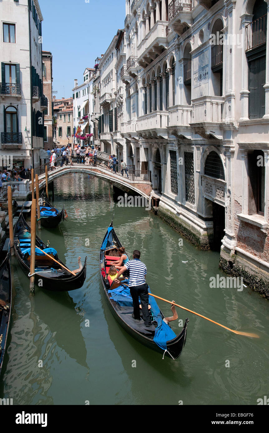 Bridge over canal Rio de la Canonica and gondalas with gondalier and ...