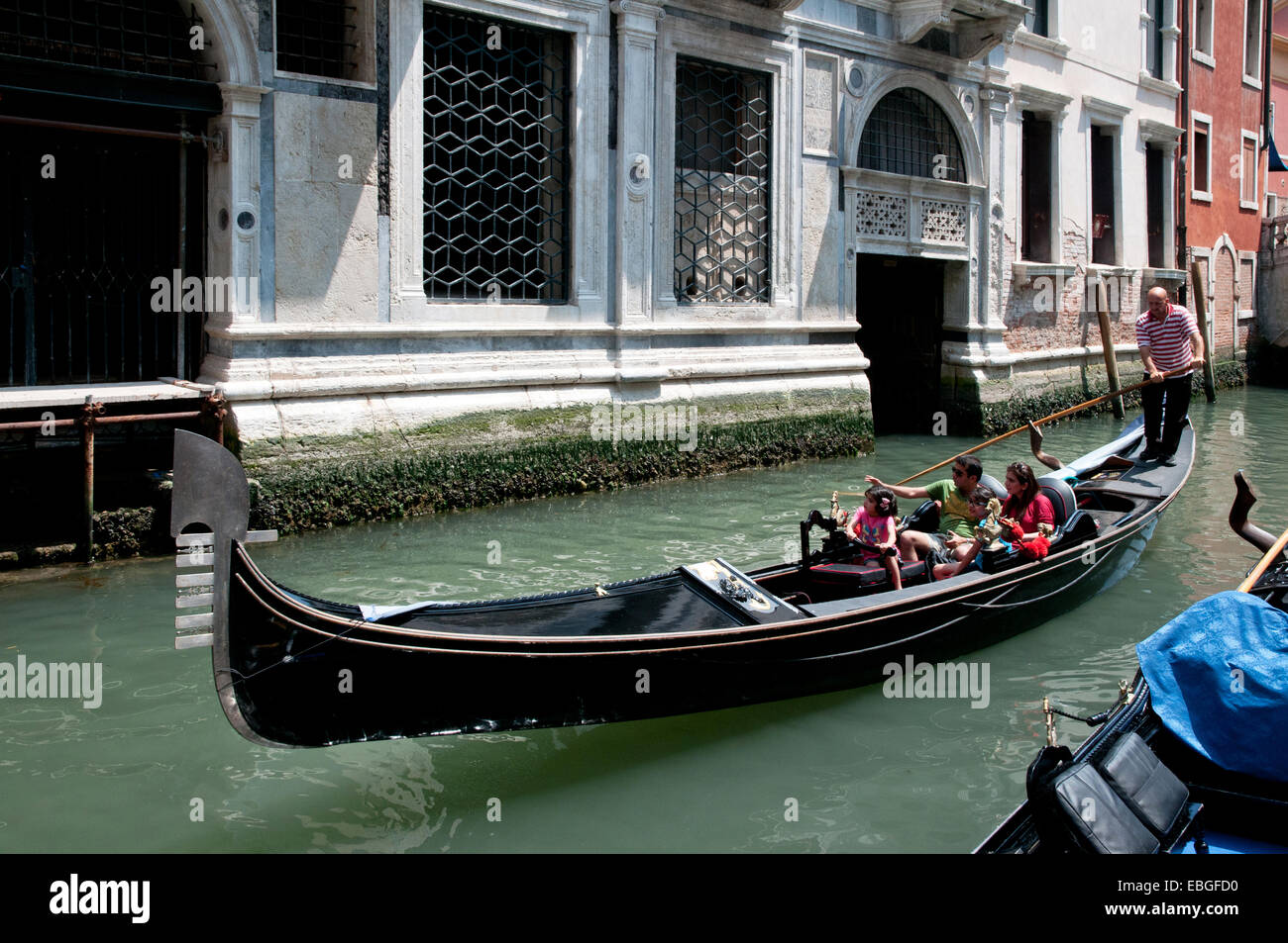 Family enjoying a gondola ride on canal Rio de la Canonica Venice Italy ...