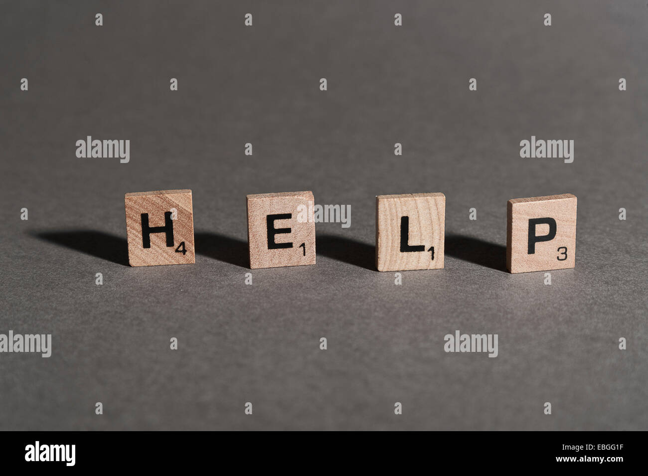 Simple collection of scrabble letters to spell out the word help. I ...