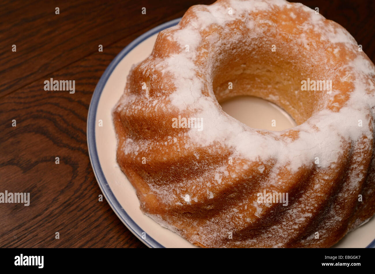 Cake with icing sugar on a plate Stock Photo - Alamy
