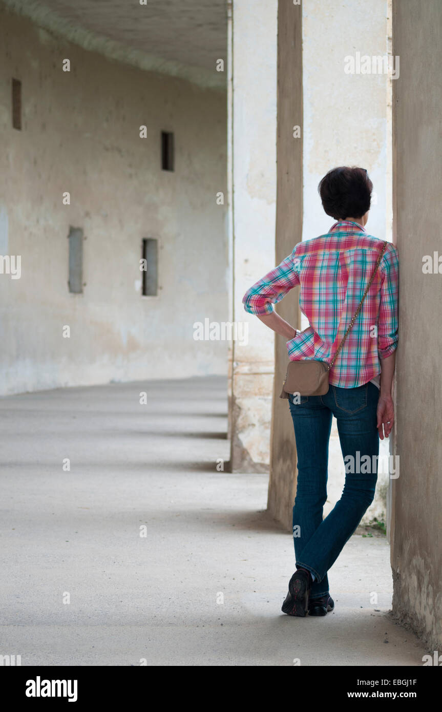 A young woman standing in the old castle gallery Stock Photo - Alamy