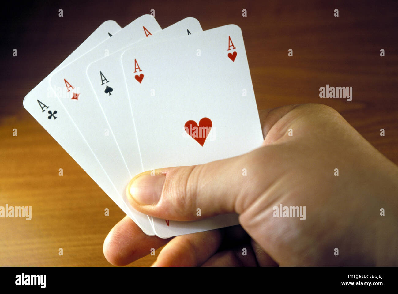 hand with cards, four aces Stock Photo - Alamy