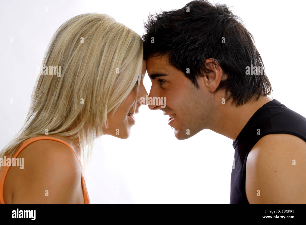 young couple going into a huddle Stock Photo - Alamy
