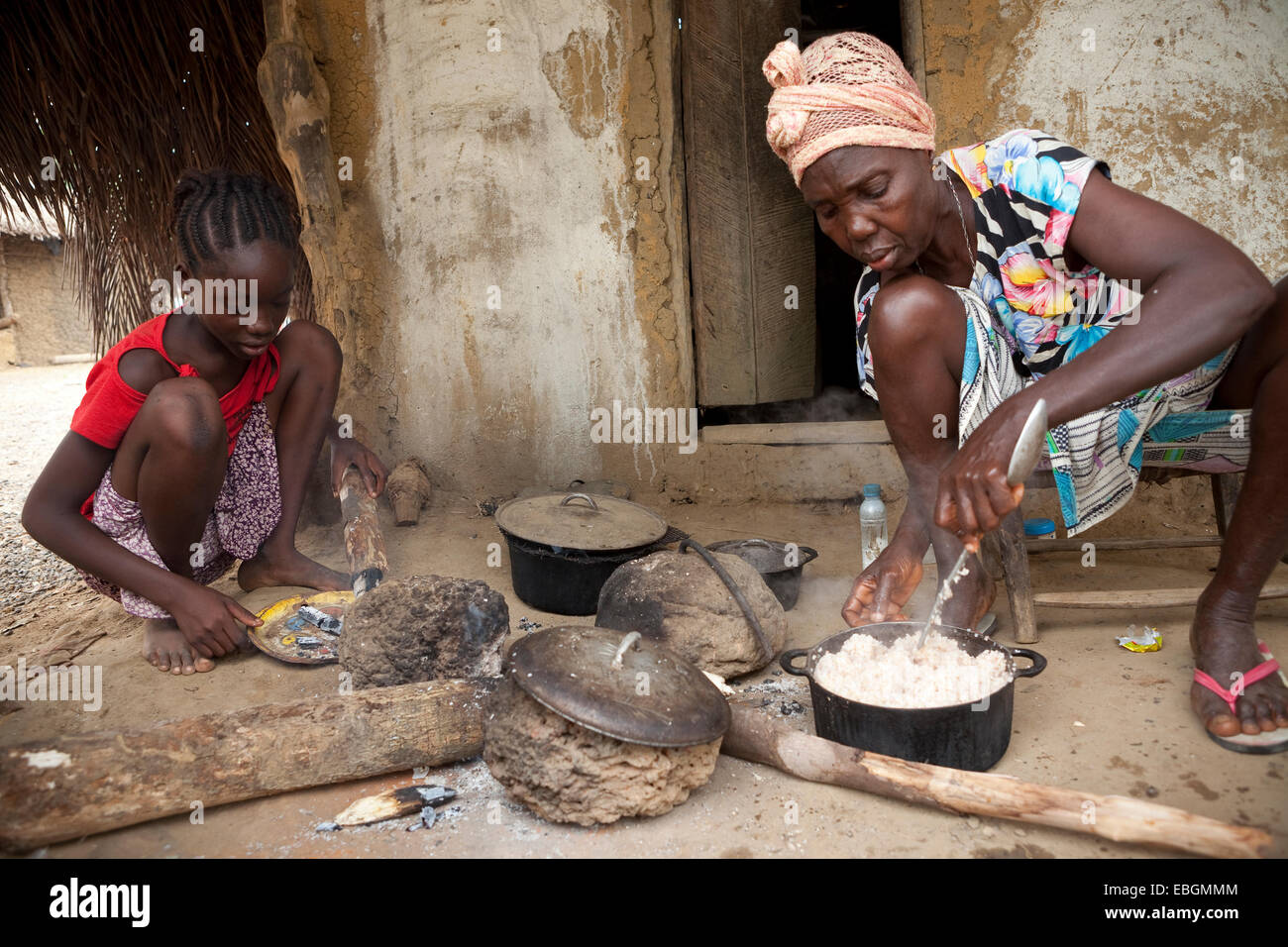 A mother and daughter prepare food together in Kakata, Liberia, West ...