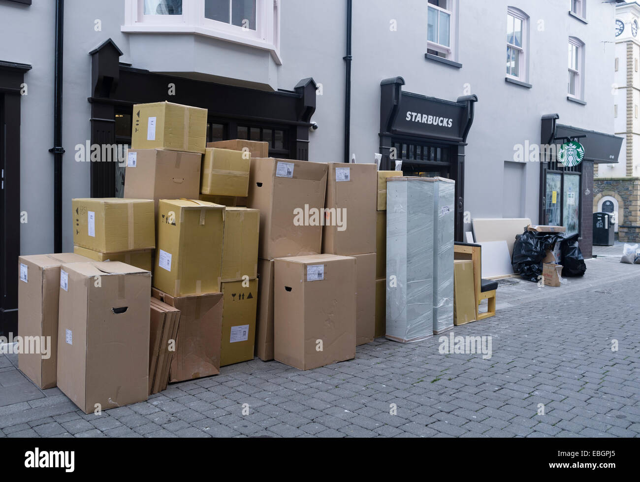 Cardboard boxes of furniture and equipment outside a new branch of ...
