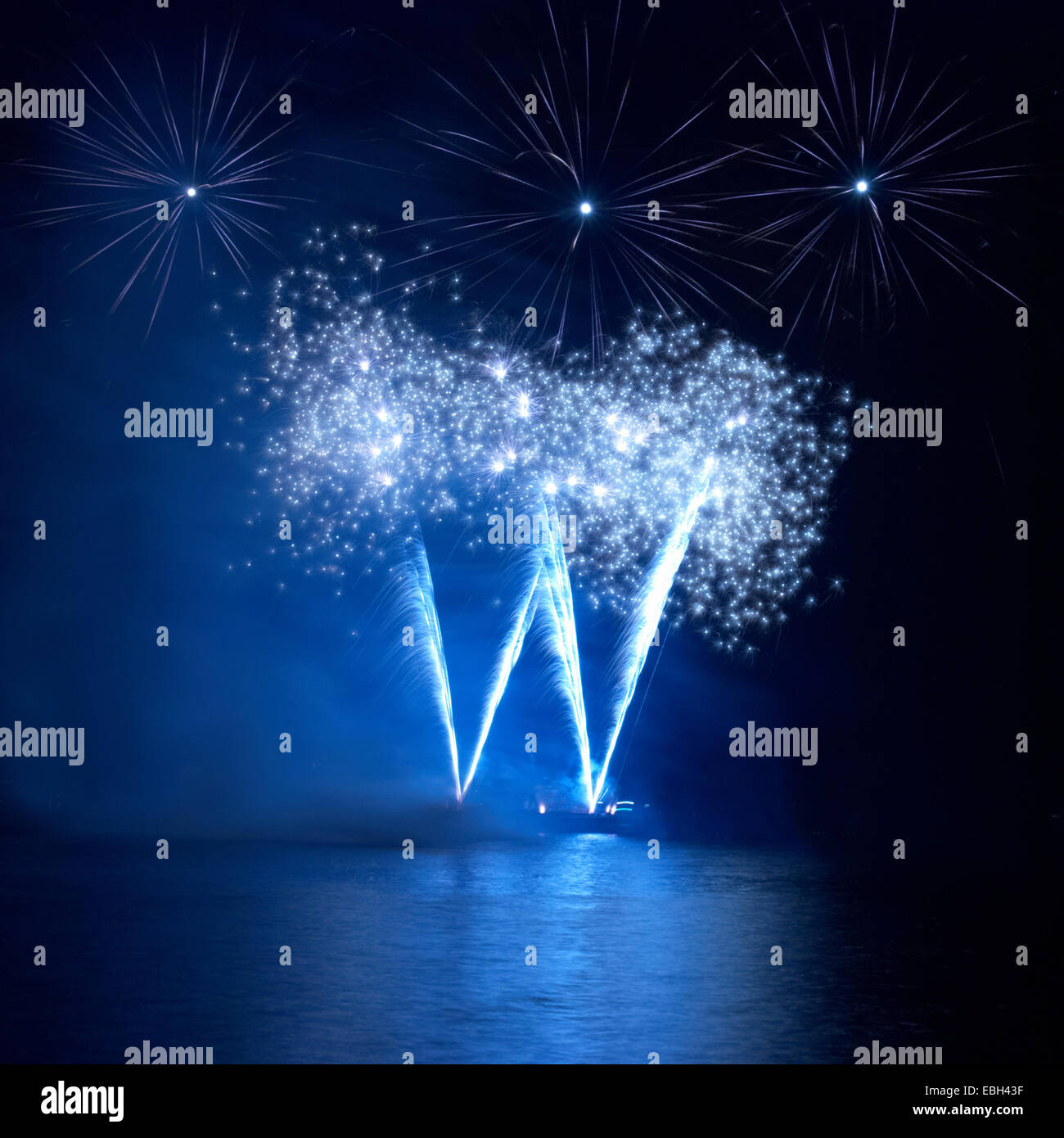 Blue fireworks on the black sky background Stock Photo - Alamy