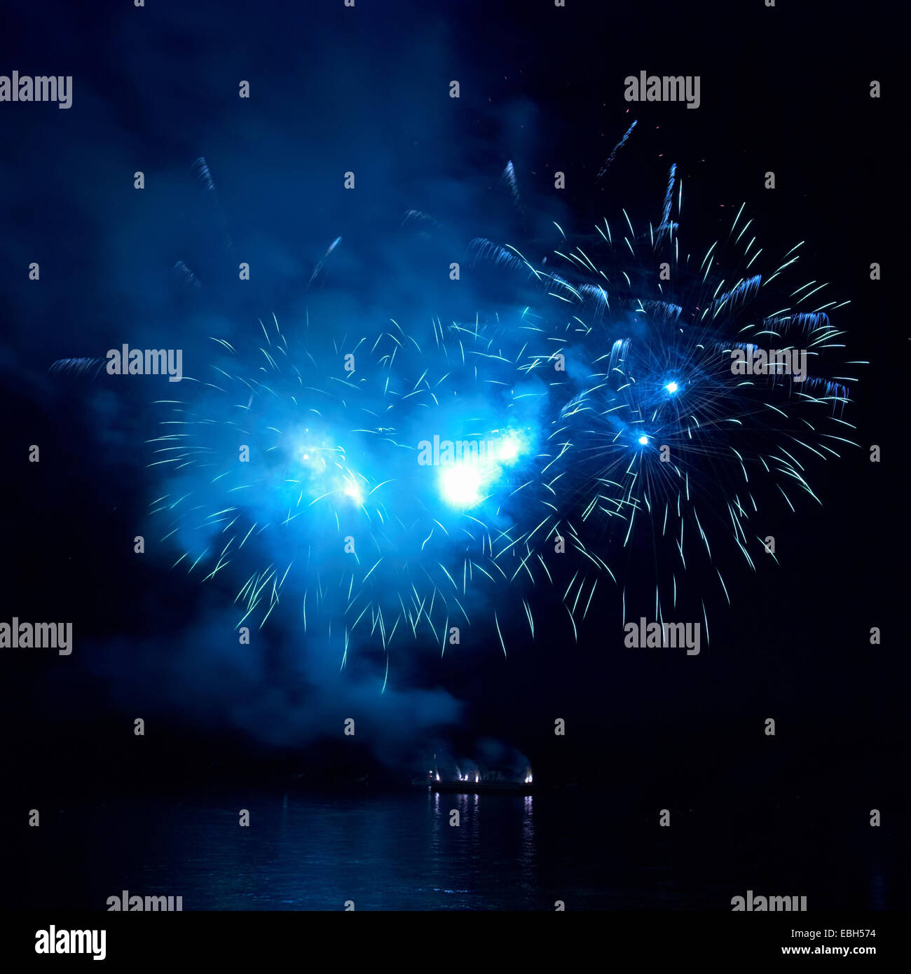 Blue fireworks on the black sky background Stock Photo - Alamy
