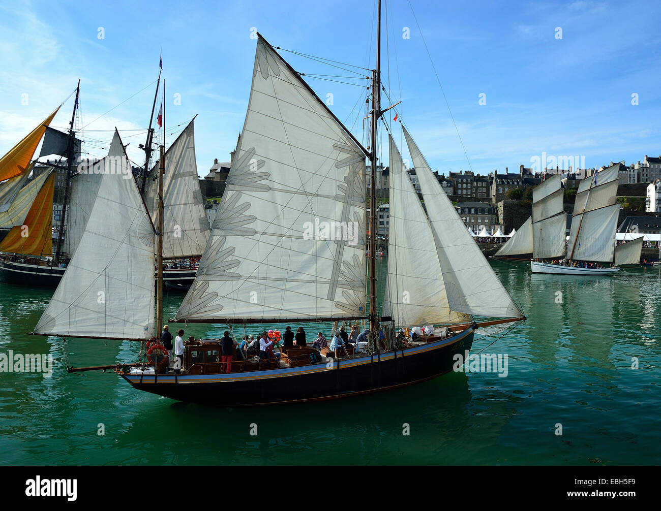Classic yacht 'Lys noir'parade under sail into the port of Granville ...
