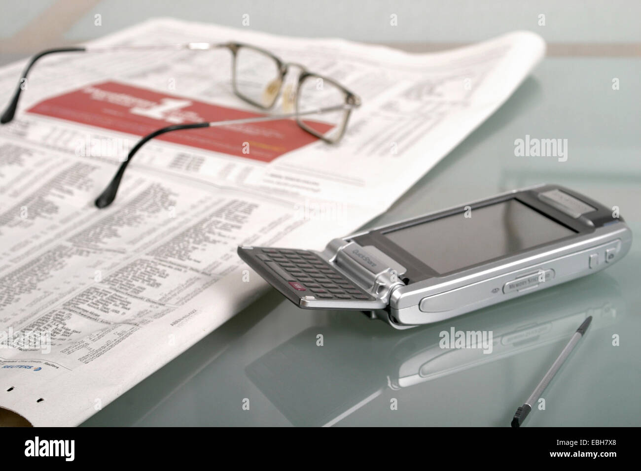 newspaper with glasses and mobile phone Stock Photo - Alamy