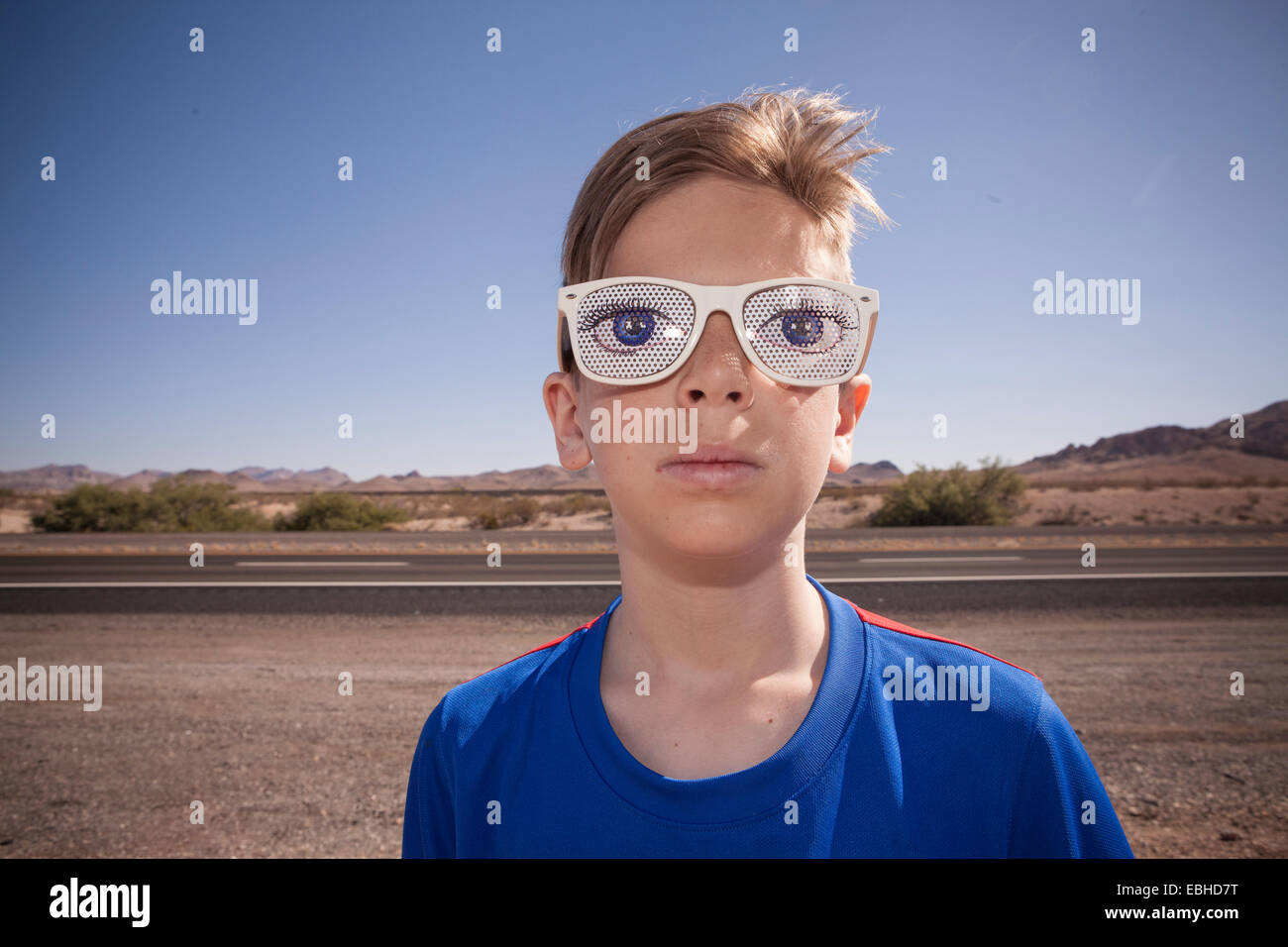 Portrait of boy on roadside wearing spectacles with staring eyes Stock ...