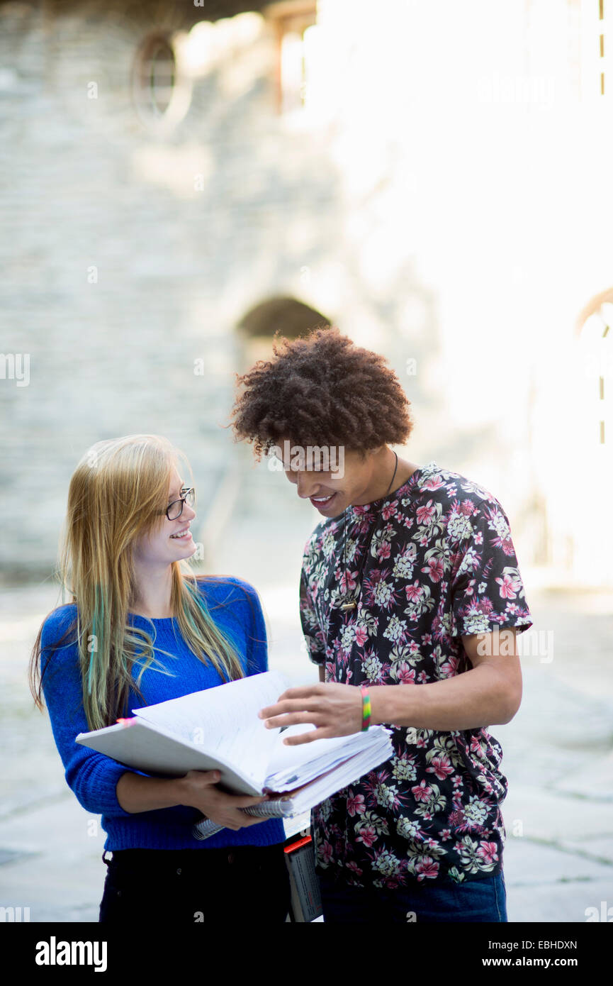 Two students looking at books Stock Photo - Alamy