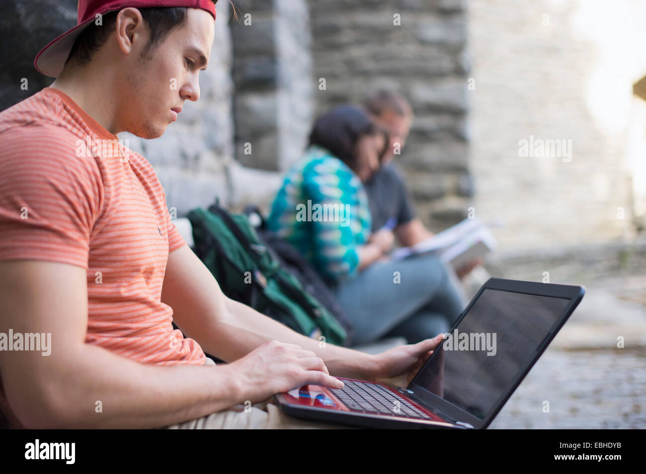 Male student using laptop Stock Photo - Alamy