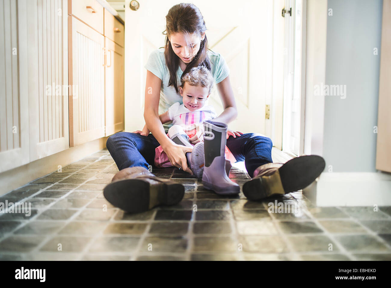Family putting on boots hi-res stock photography and images - Alamy