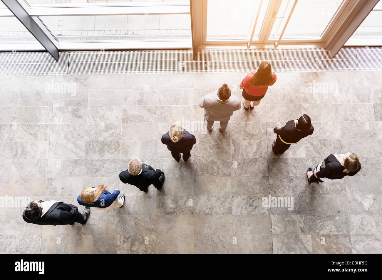 Overhead view of business team looking out of office window Stock Photo ...