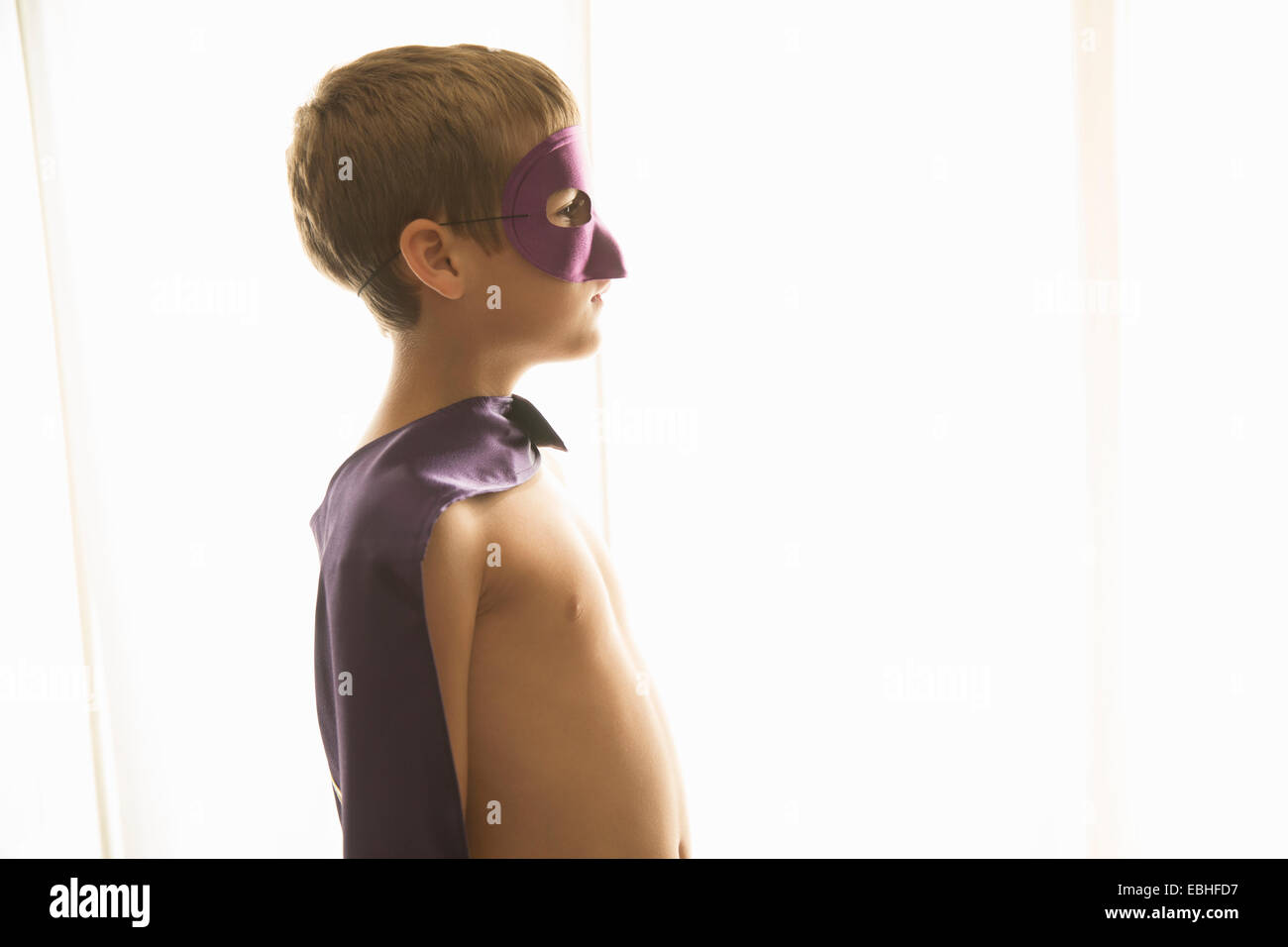 Boy in cape and mask at home Stock Photo - Alamy